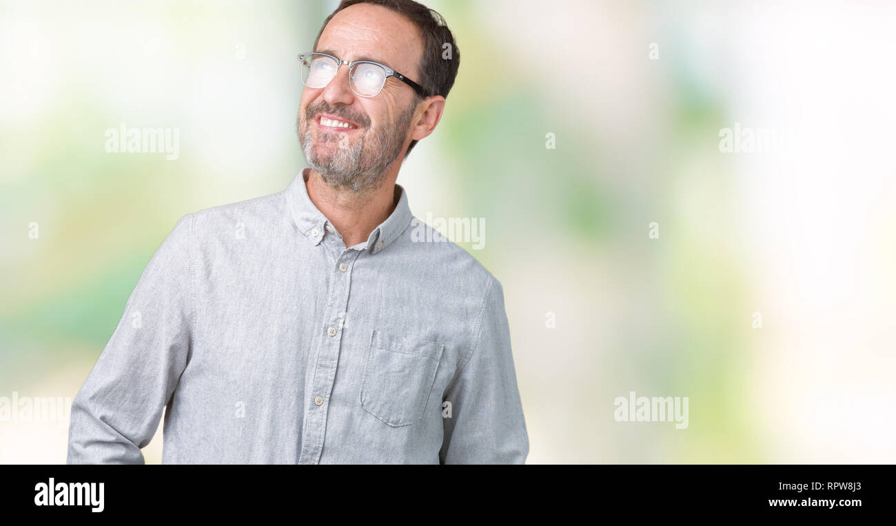 Handsome middle age elegant senior man wearing glasses over isolated ...