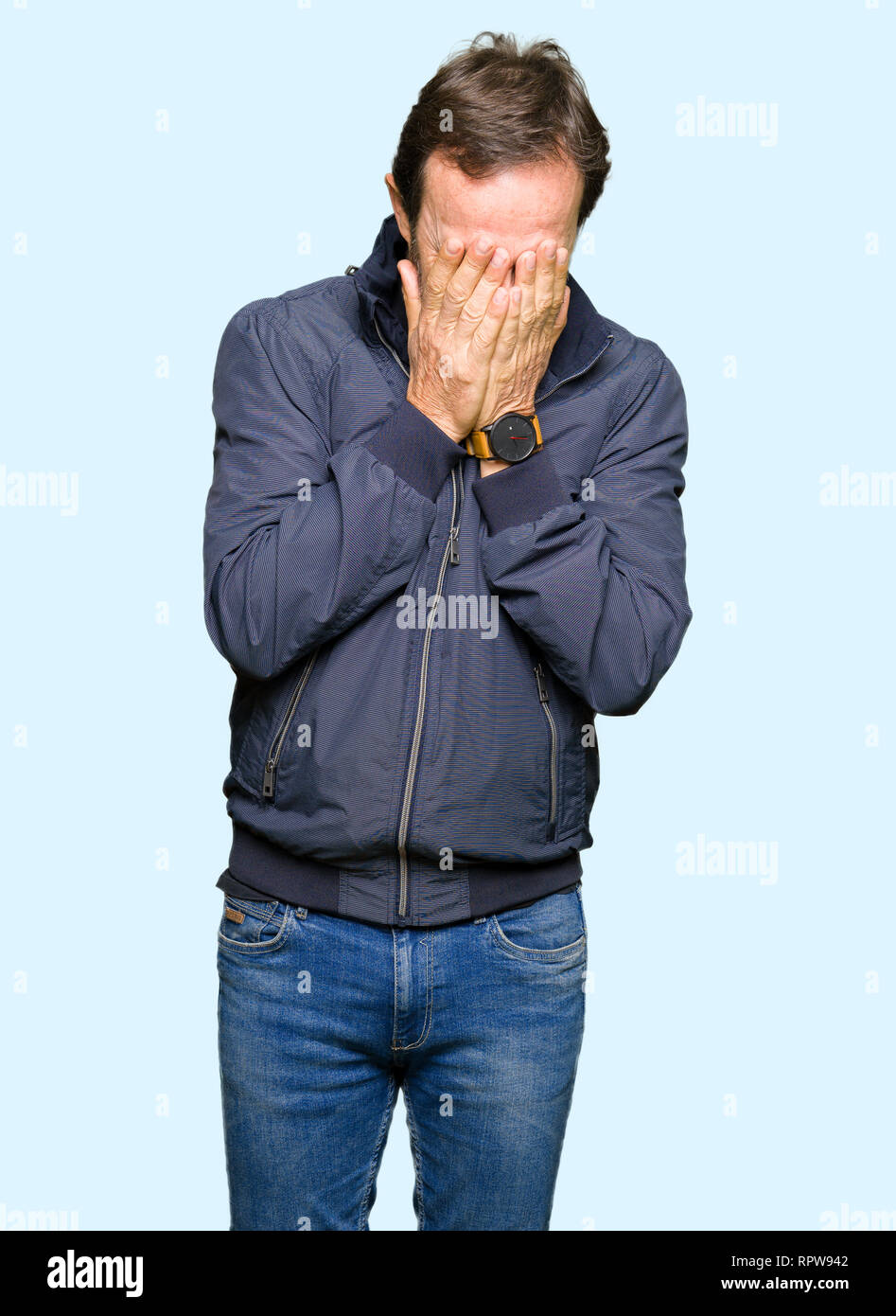 Middle age handsome man wearing a jacket with sad expression covering ...