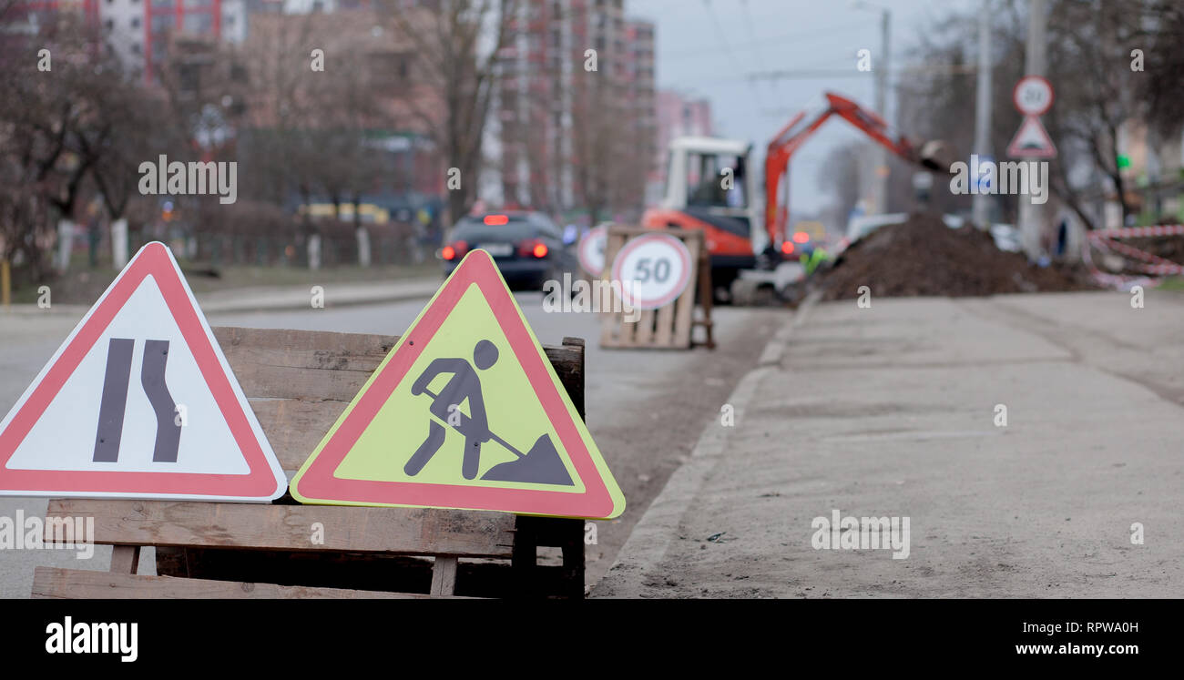 Road signs, detour, road repair on street background, truck and ...