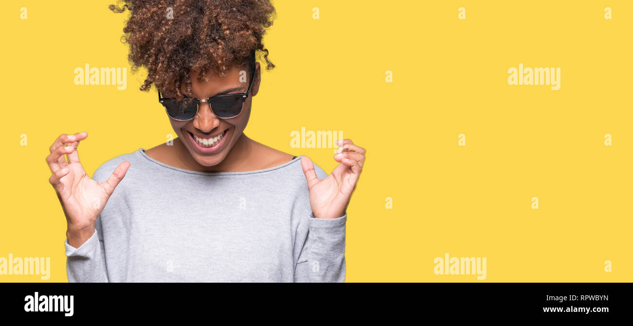 Beautiful young african american woman wearing sunglasses over isolated ...