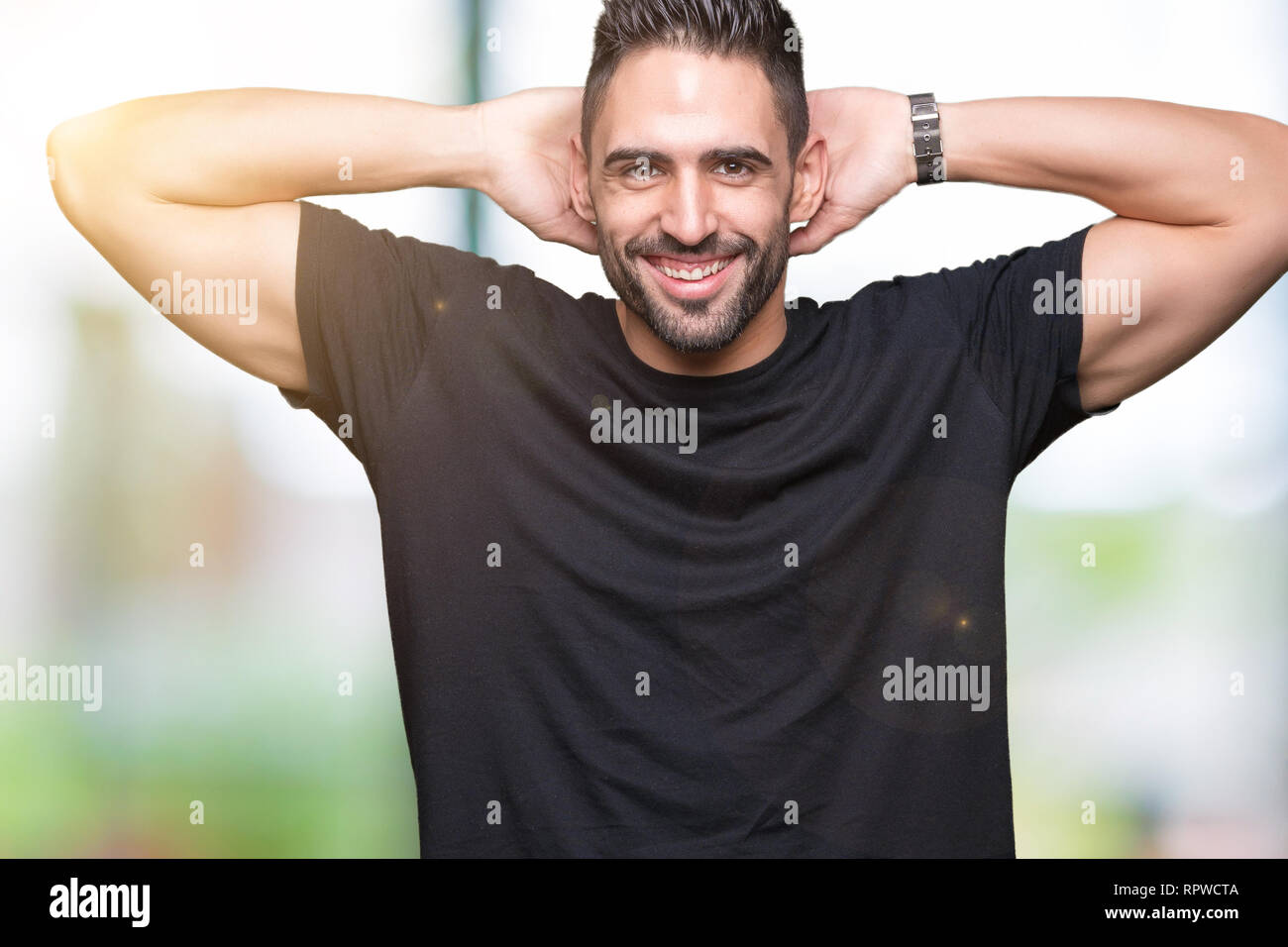 Young handsome man over isolated background Relaxing and stretching ...