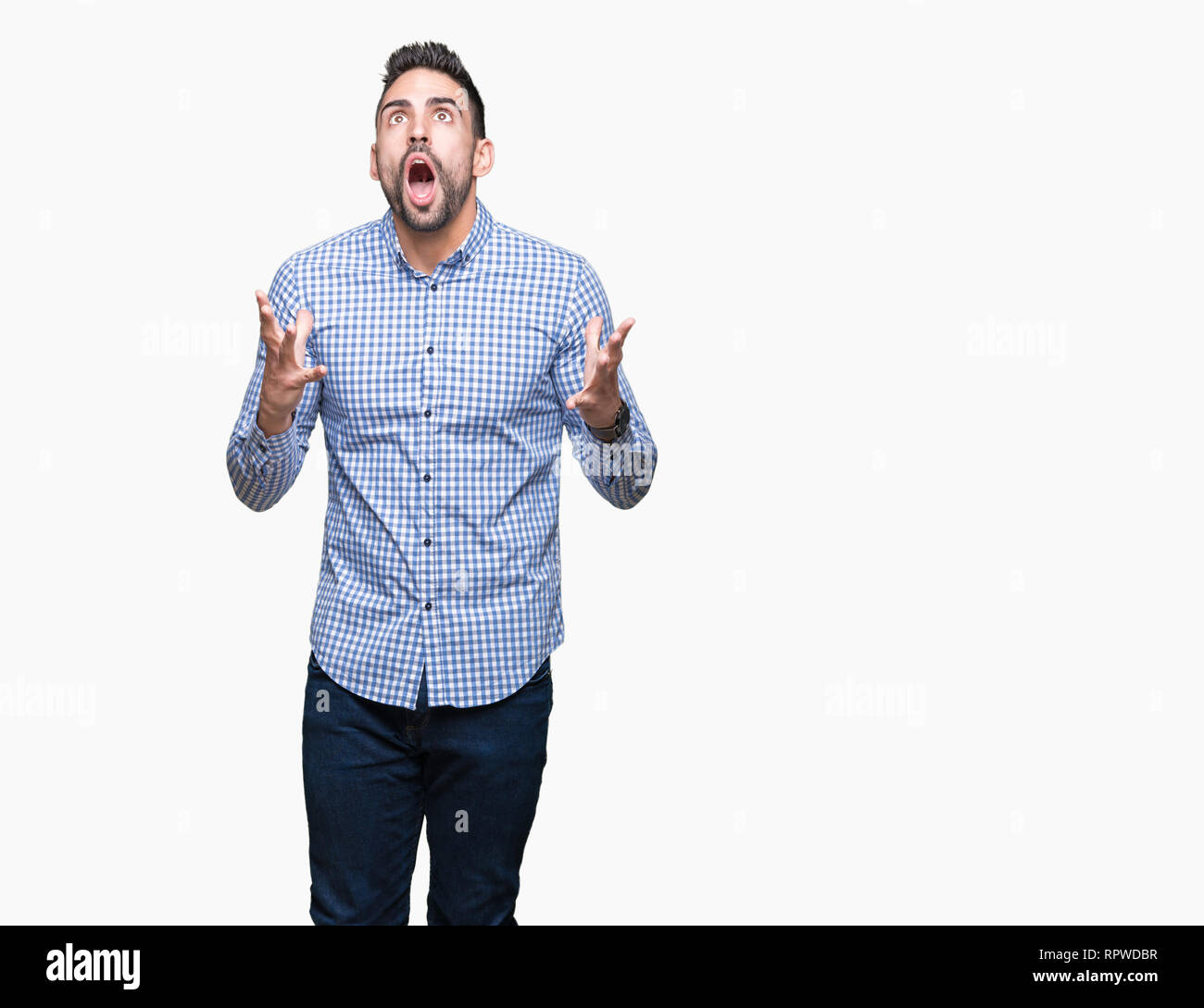 Young handsome man over isolated background crazy and mad shouting and ...