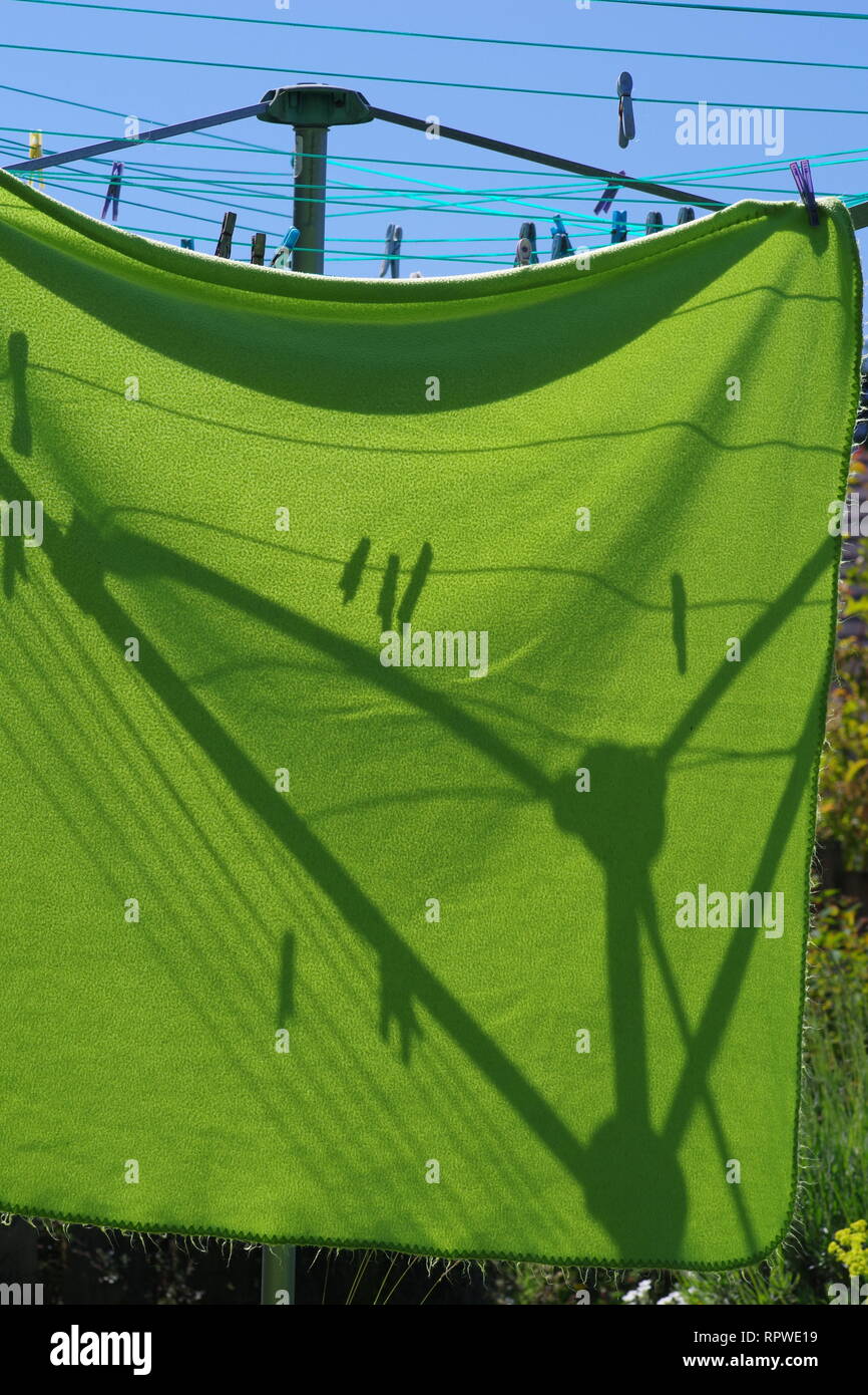 Green Blanket Drying on a Rotary Washing Clothes Line in a Garden on a ...