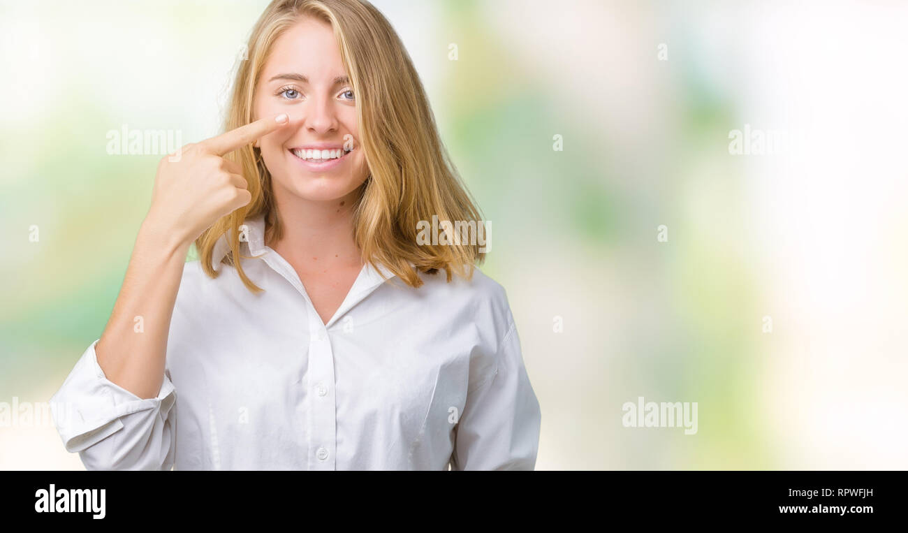 Beautiful young business woman over isolated background Pointing with ...