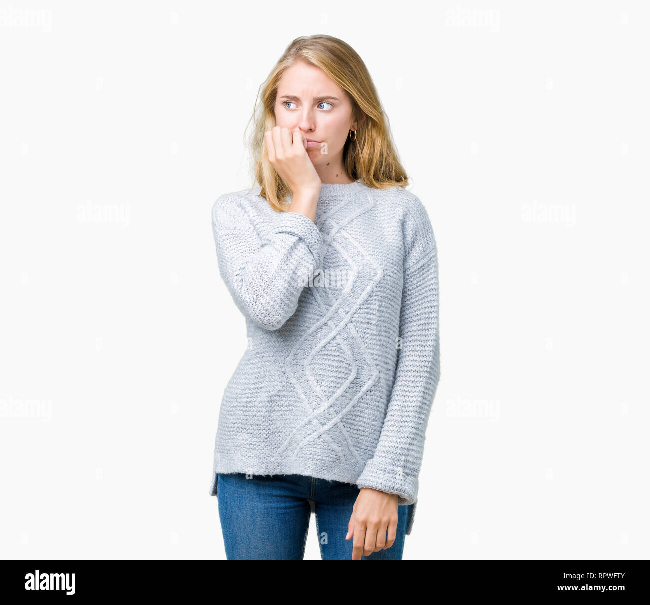 Beautiful young woman wearing winter sweater over isolated background ...