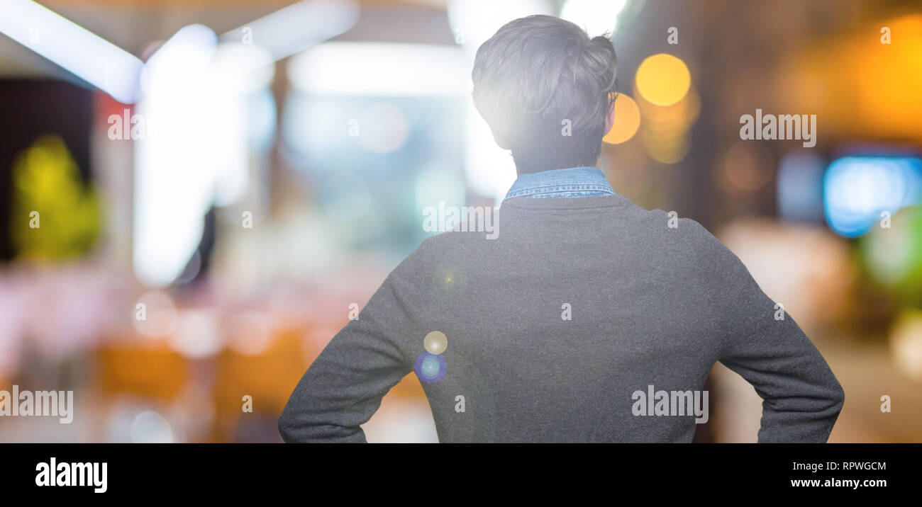 Young handsome elegant man over isolated background standing backwards ...