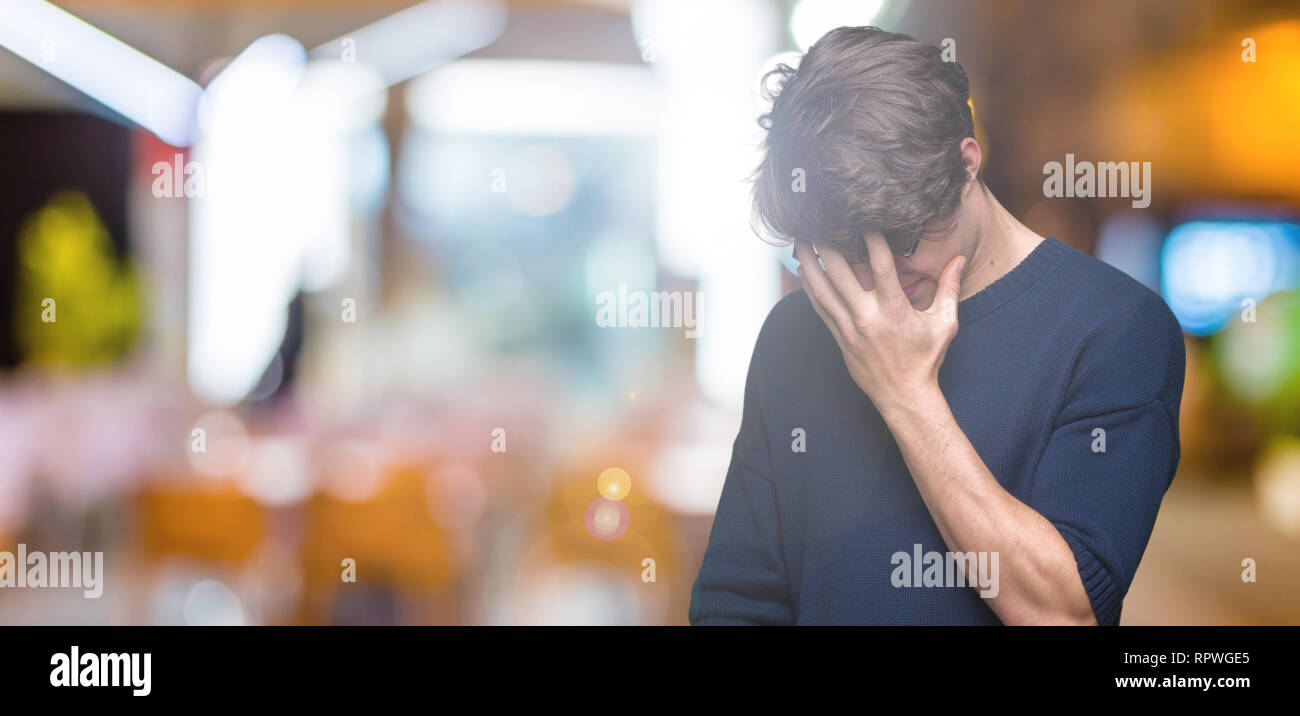 Young handsome man wearing glasses over isolated background with sad ...