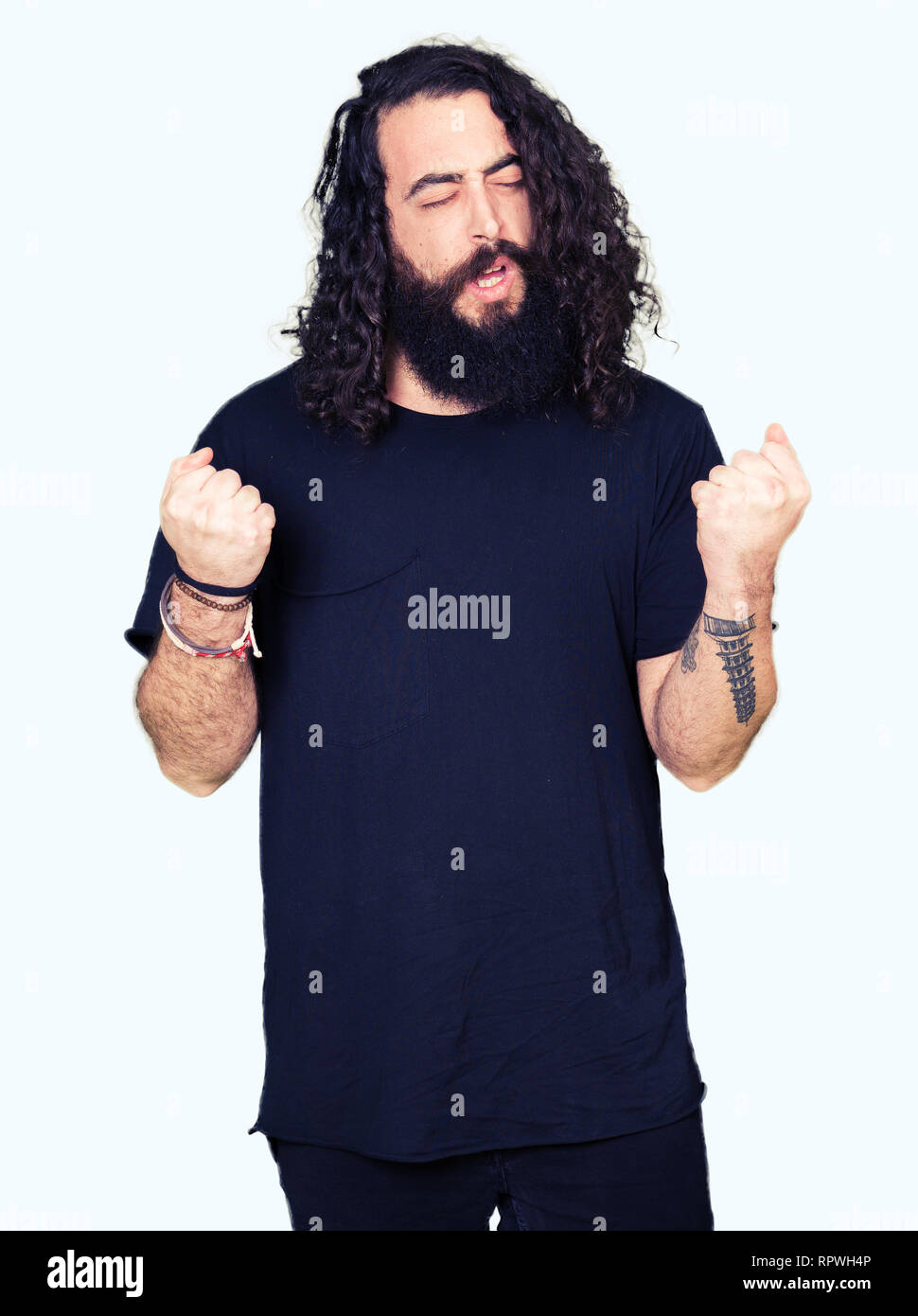 Young man with long hair and beard wearing heavy metal black outfit ...