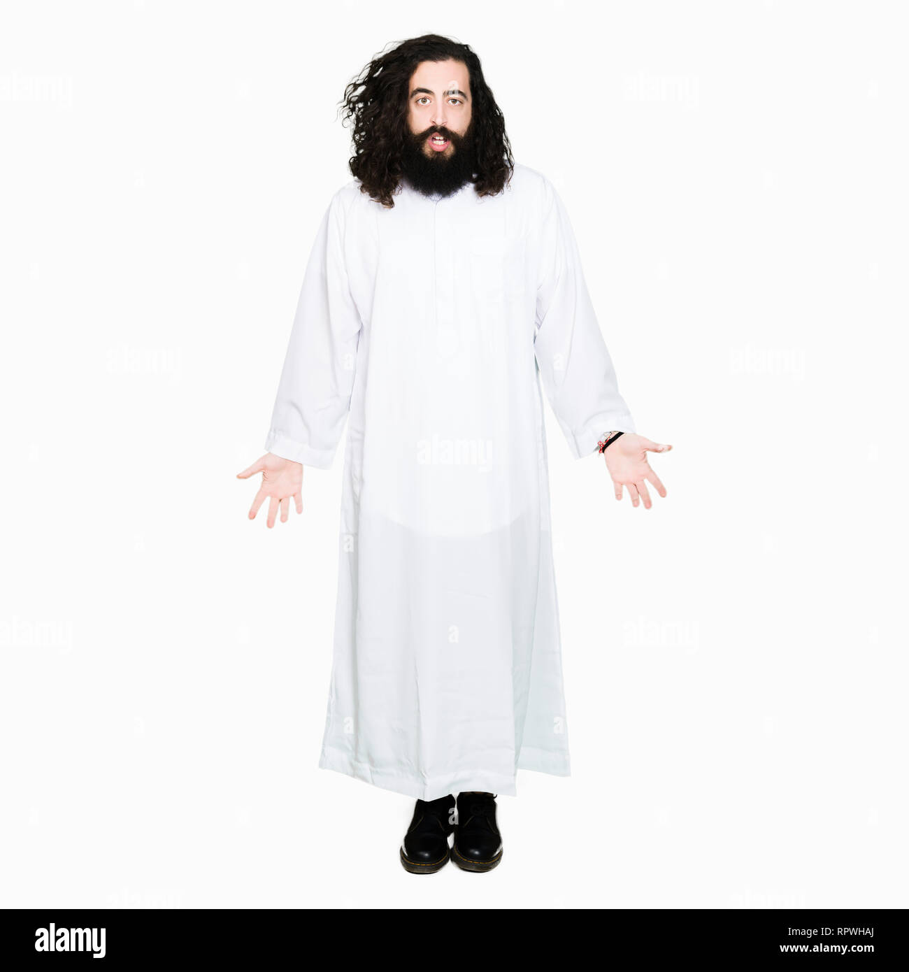 Man wearing Jesus Christ costume afraid and shocked with surprise ...