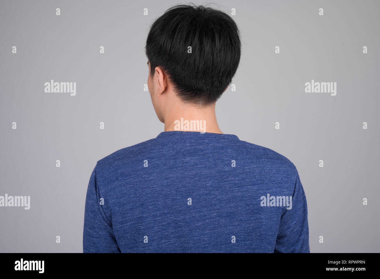Rear view head shot of young Asian man against white background Stock ...