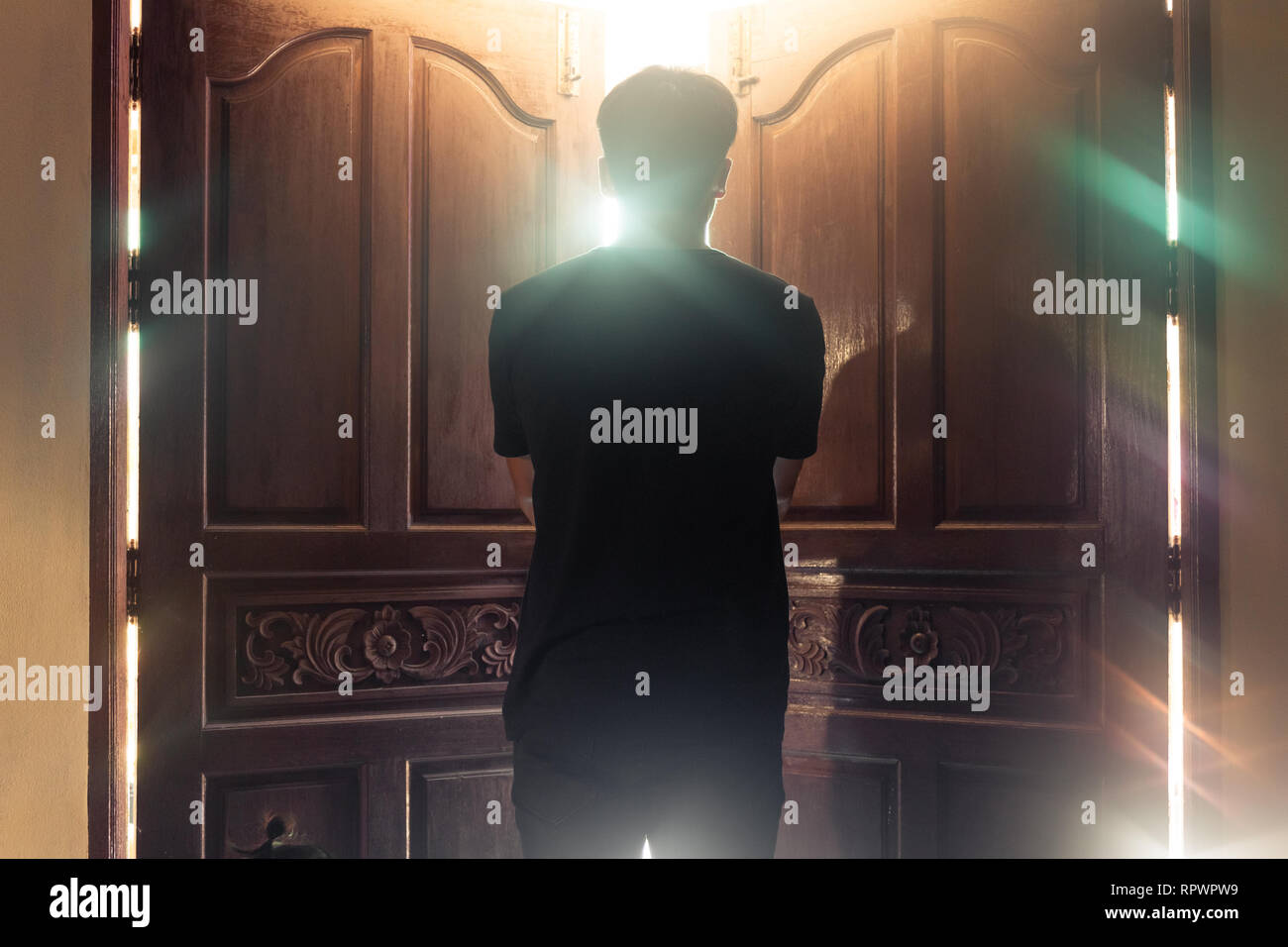 Men open the door to light Stock Photo - Alamy