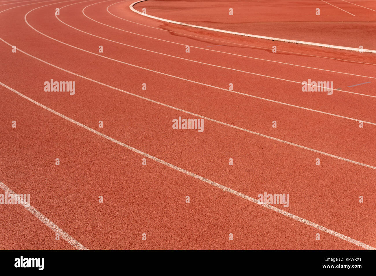Red running track in stadium Stock Photo - Alamy