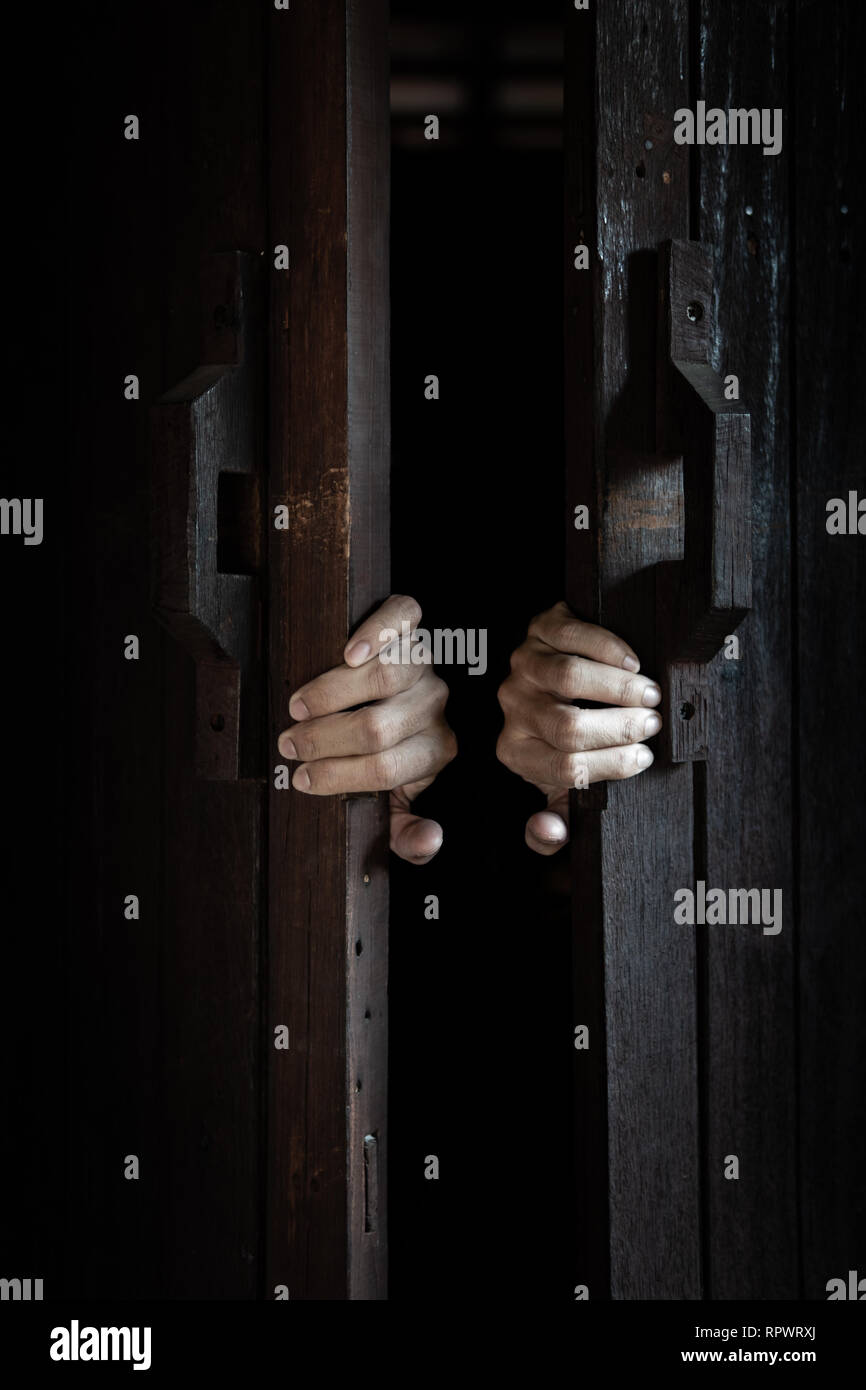 Hands open the wooden door from the inside of the dark room Stock Photo ...
