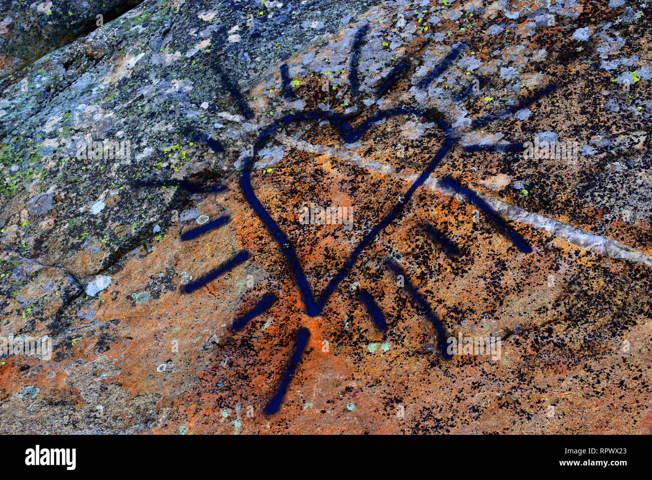 A heart sprayed with black on a rock formation with vivid colors Stock ...