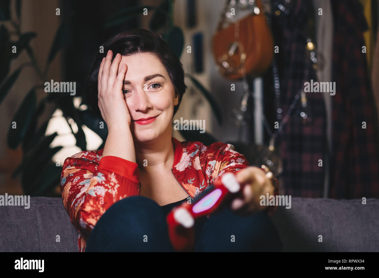 Beautiful young gamer disappointed with the outcome of her gaming ...