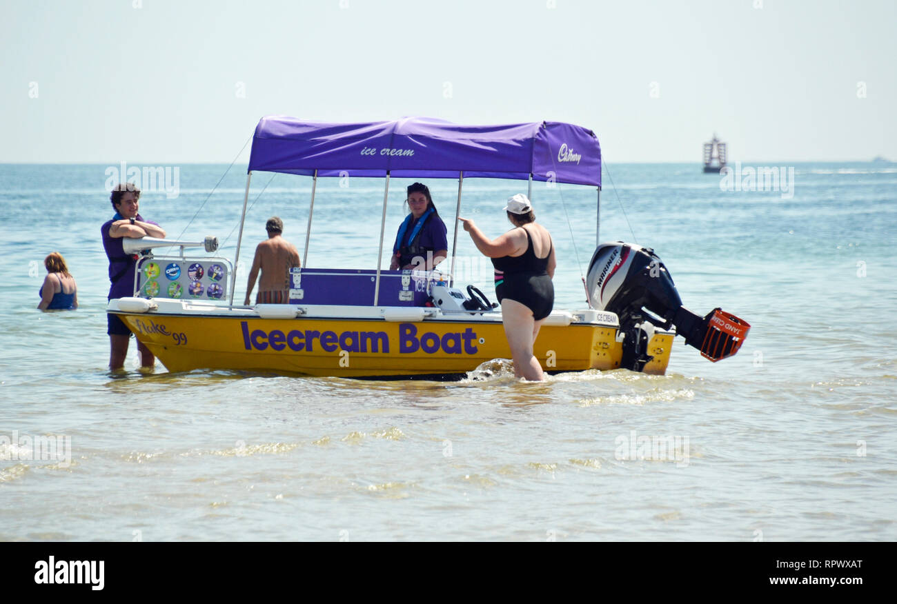 Cadbury's Ice Cream Boat doing a good trade in the sea at Shell Bay ...