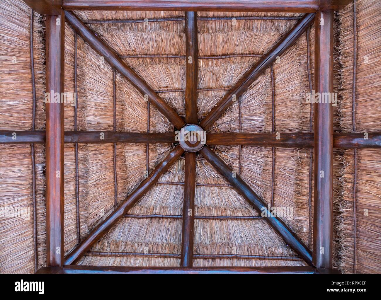 View from below of a thatched tropical beach parasol umbrella made ...