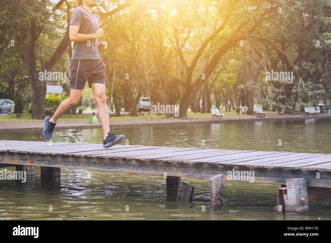 runner man running on wood bridge over canal Stock Photo - Alamy