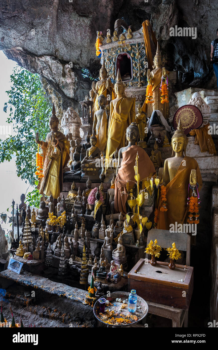 Hundreds of old and faded Buddha statues inside the Tham Ting Cave at ...