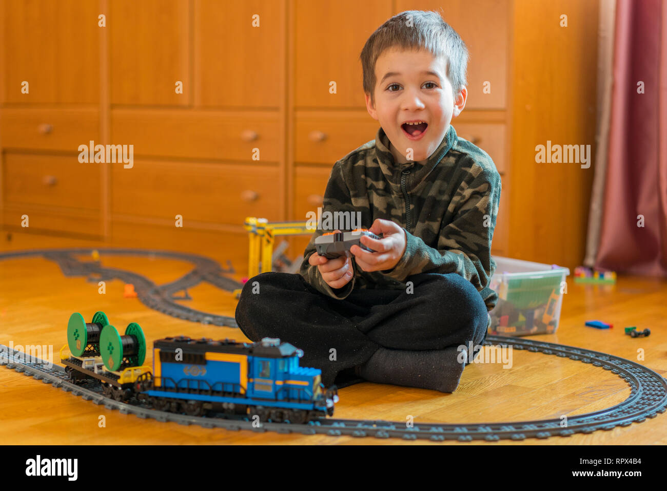 Little boy playing with a toy railway. Little boy playing with railway ...
