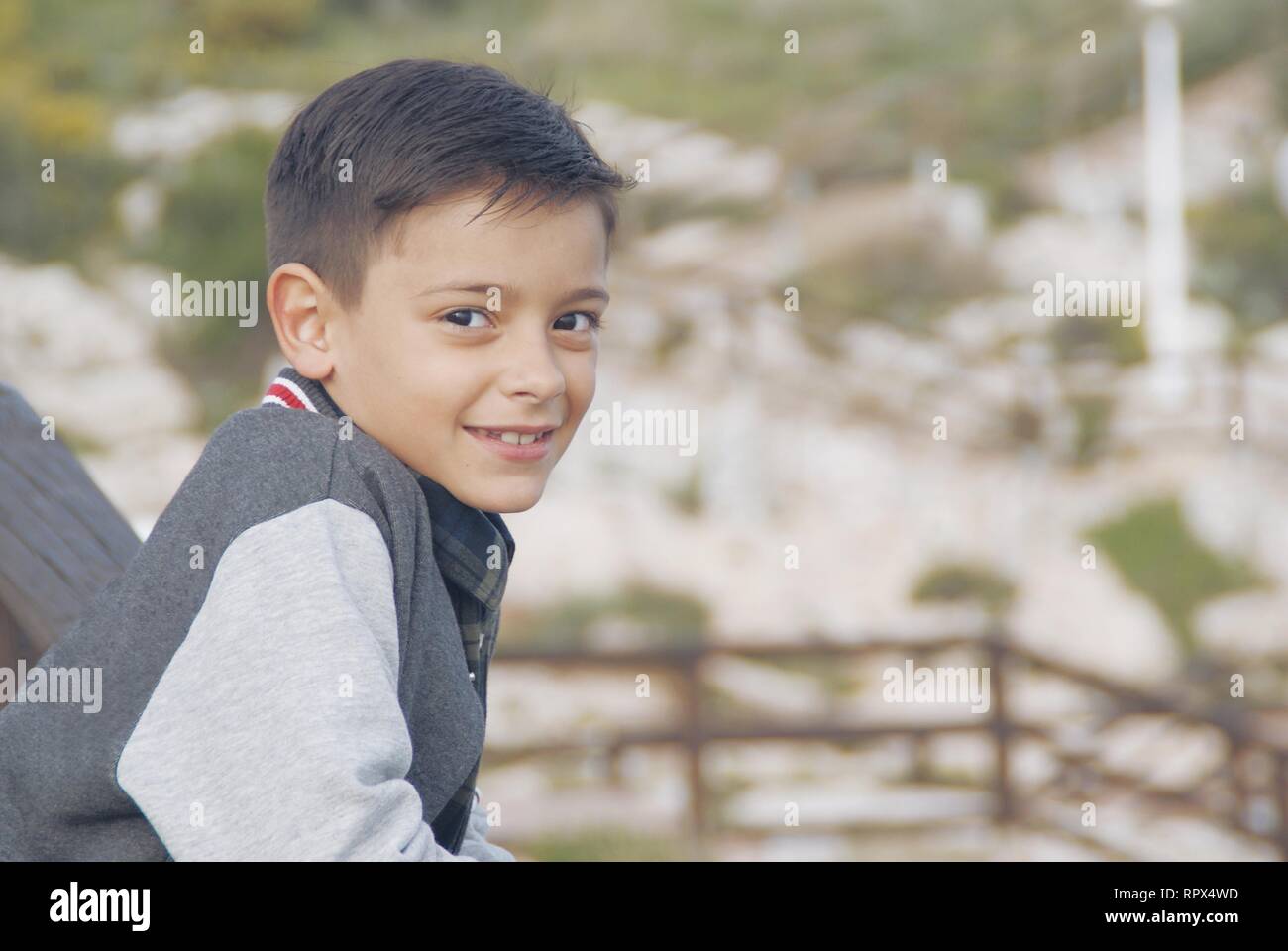 Boy leaning railing outdoors hi-res stock photography and images - Alamy