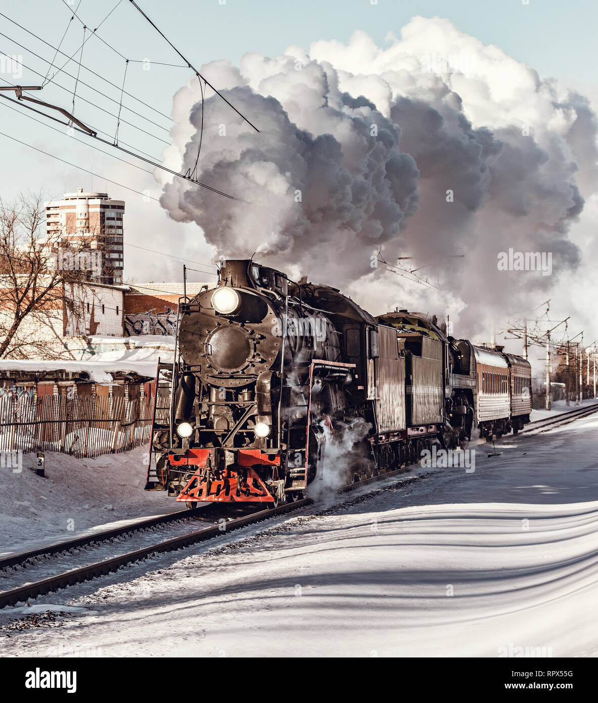 Steam train moves toward at cold winter morning time Stock Photo - Alamy