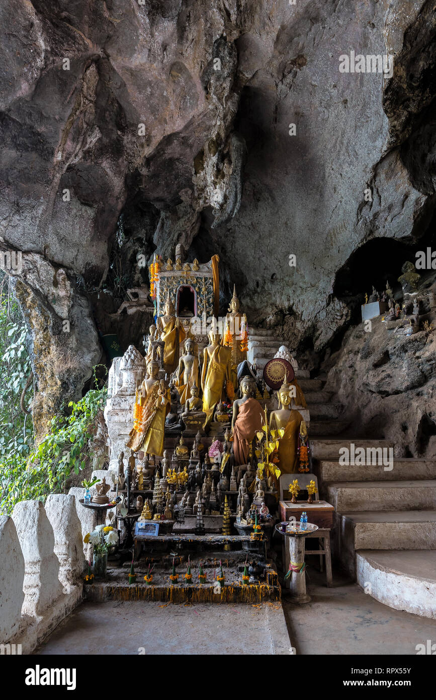 Hundreds of old and faded Buddha statues inside the Tham Ting Cave at ...