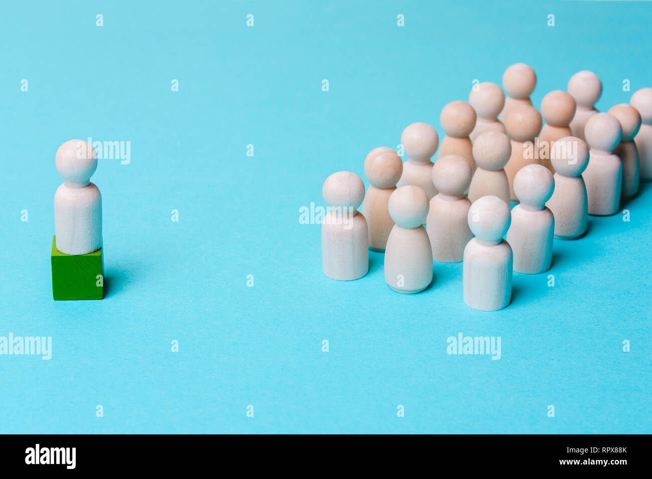 Wooden figures on a blue background. Leader and team. Business ...