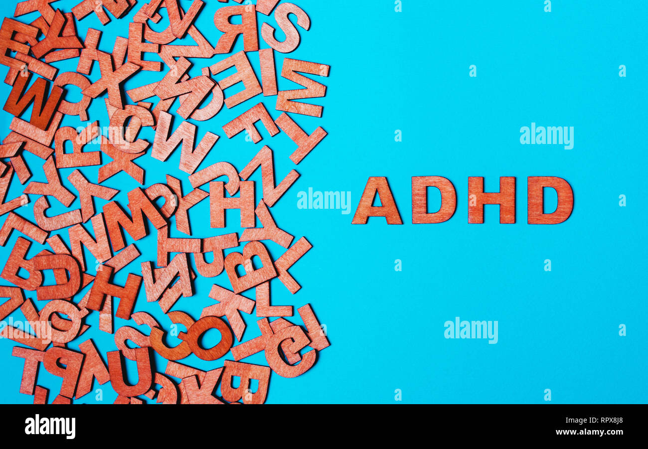 Word ADhD from wooden letters on a blue background. attention deficit ...