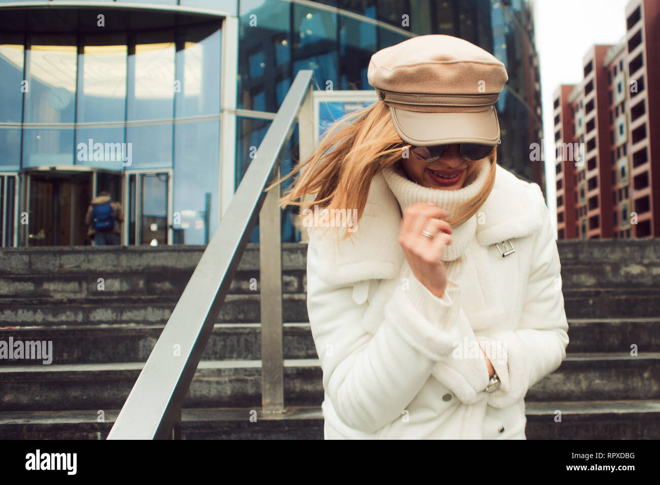 Stylish and elegant young woman on the background of the business ...