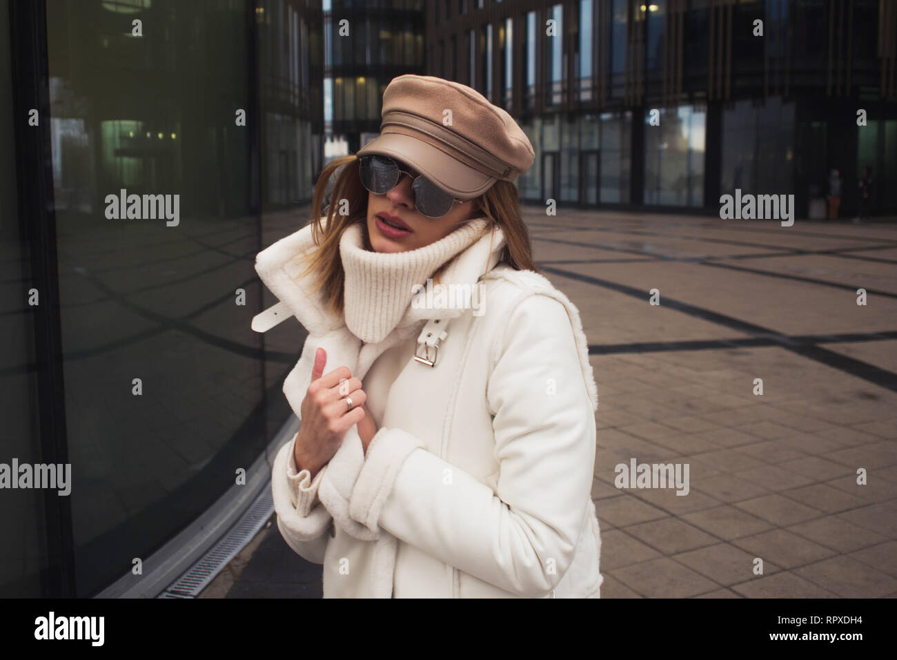 Stylish and elegant young woman on the background of the business ...
