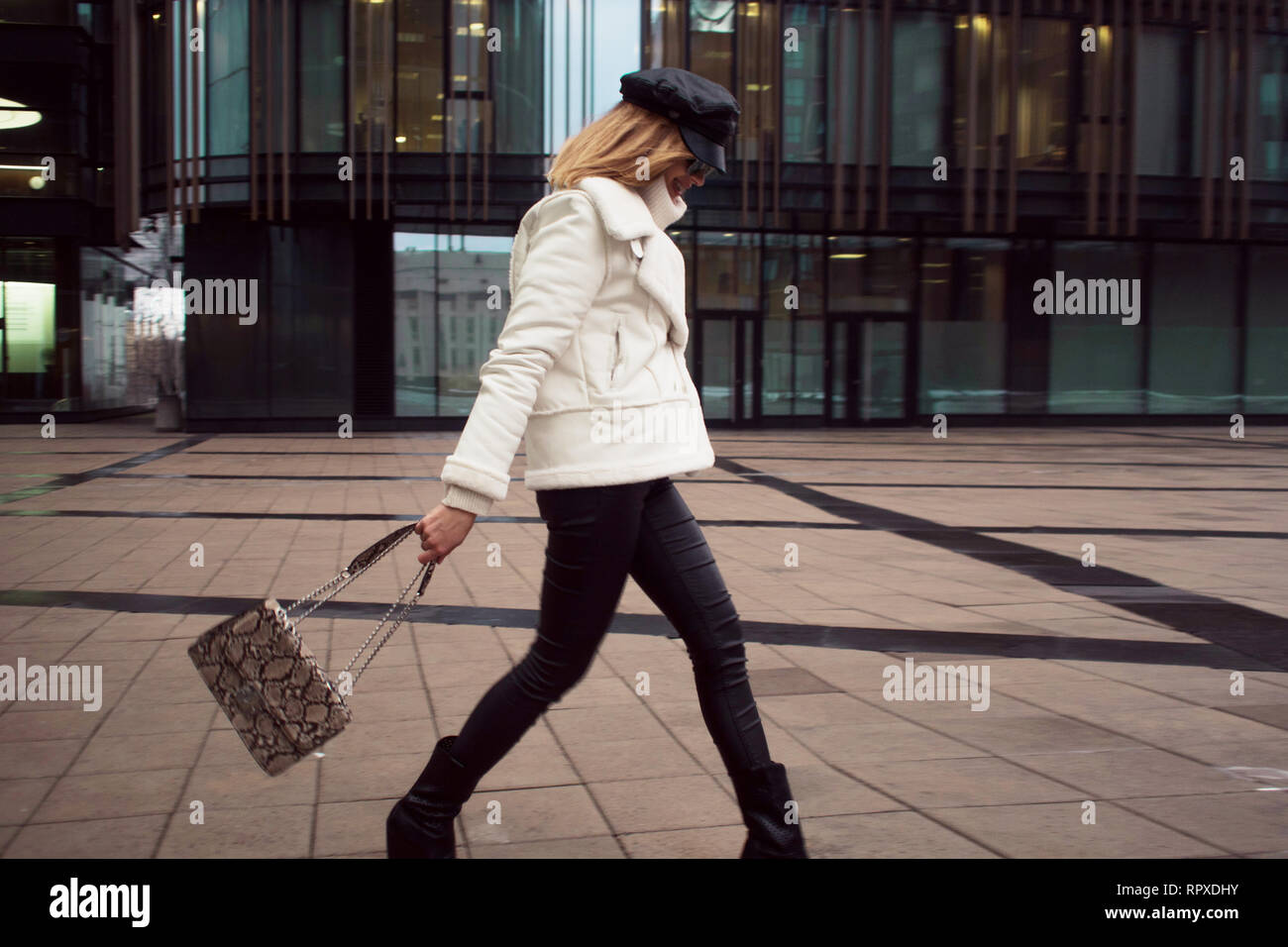 Stylish and elegant young woman on the background of the business ...