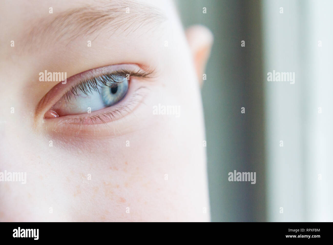 Baby blue beautiful, brooding eyes of a boy Stock Photo - Alamy