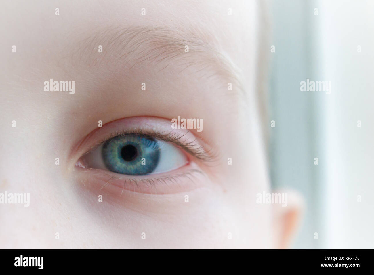 Baby blue beautiful, brooding eyes of a boy Stock Photo - Alamy