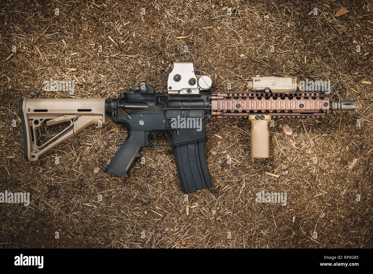 light assault rifle on the forest background Stock Photo - Alamy