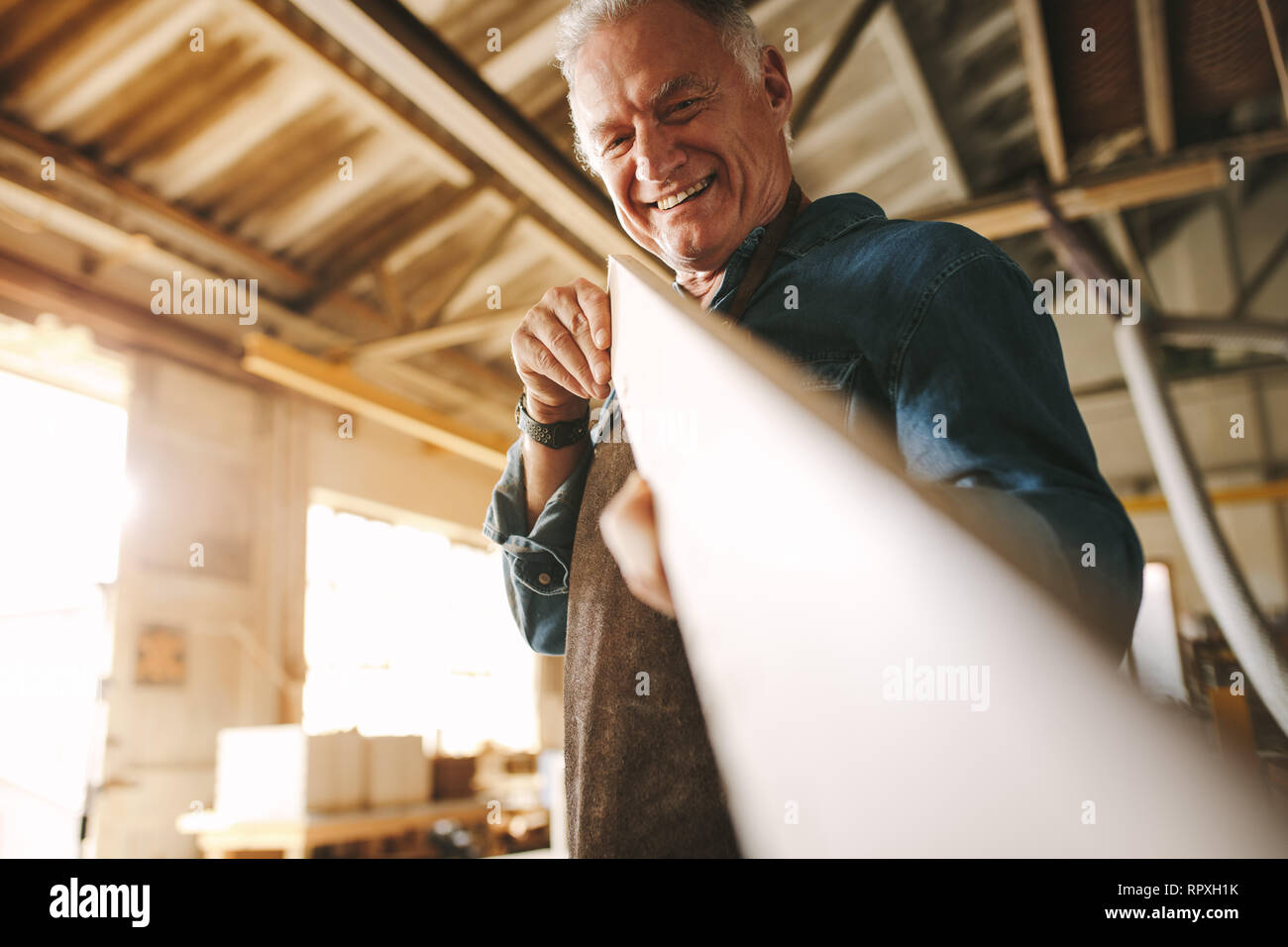 Senior carpenter checking if the board is flat and even. Carpenter ...