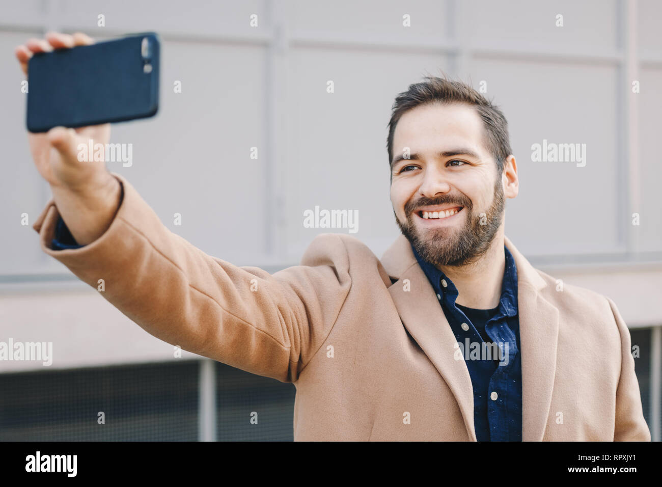 Close-up portrait of attractive and modern young man having a video ...