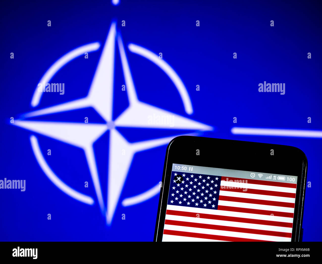 USA flag on the phone display on the background of the NATO flag Stock ...