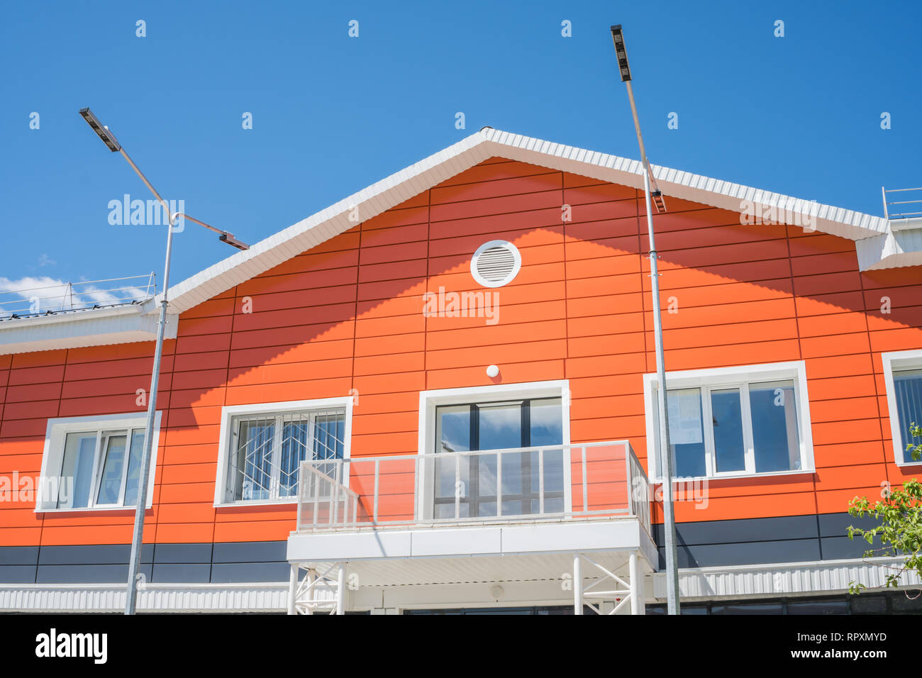 The facade of a residential building in orange color Stock Photo - Alamy