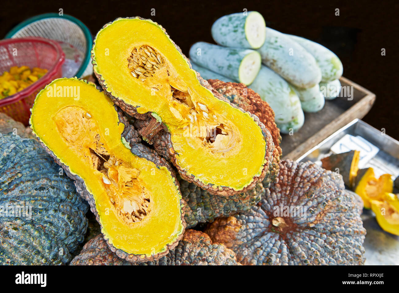 Close-up of cut open blue colored squash and bottle gourd vegetable at ...