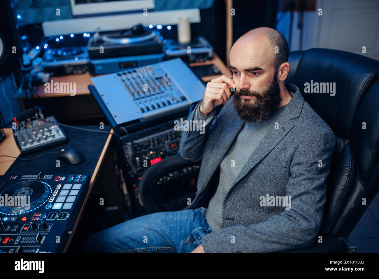 Sound engineer working at the remote control panel in the recording ...