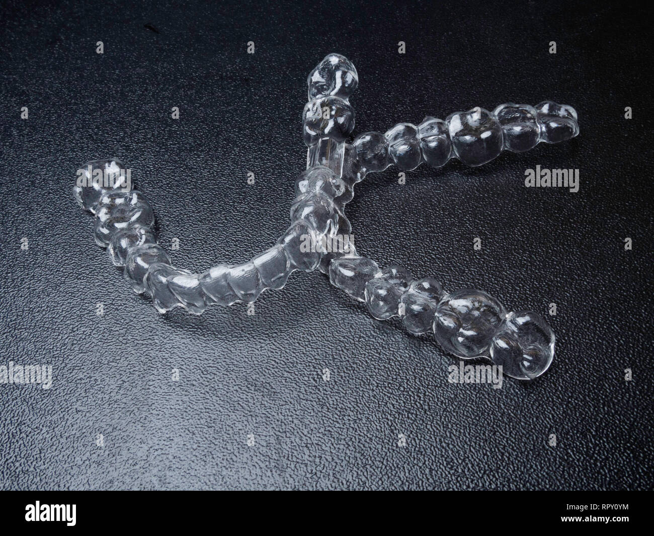 braces or invisible retainer, orthodontic equipment on black background ...