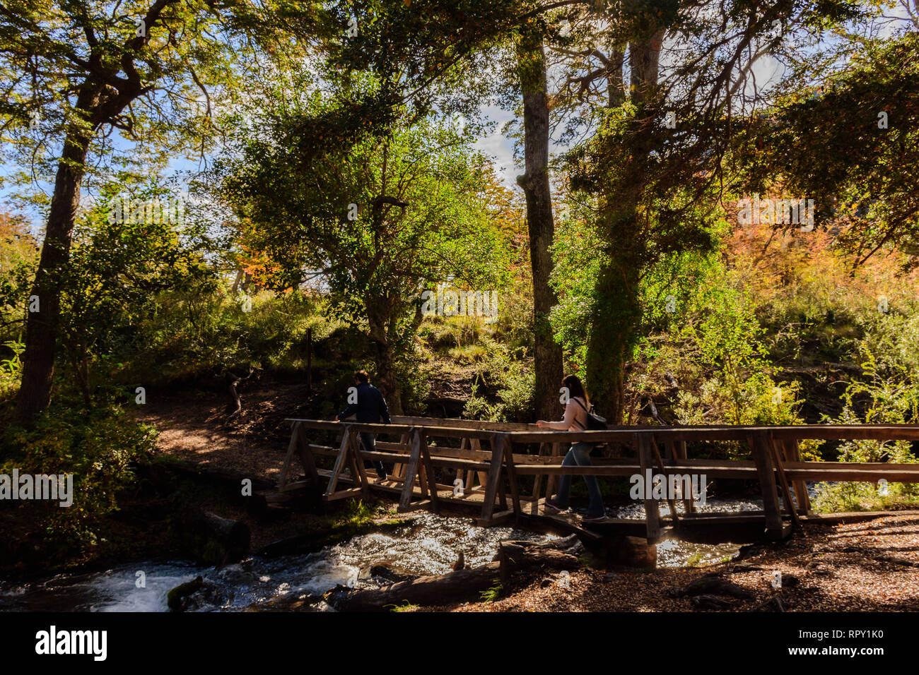 people crossing a wooden bridge over river Stock Photo - Alamy