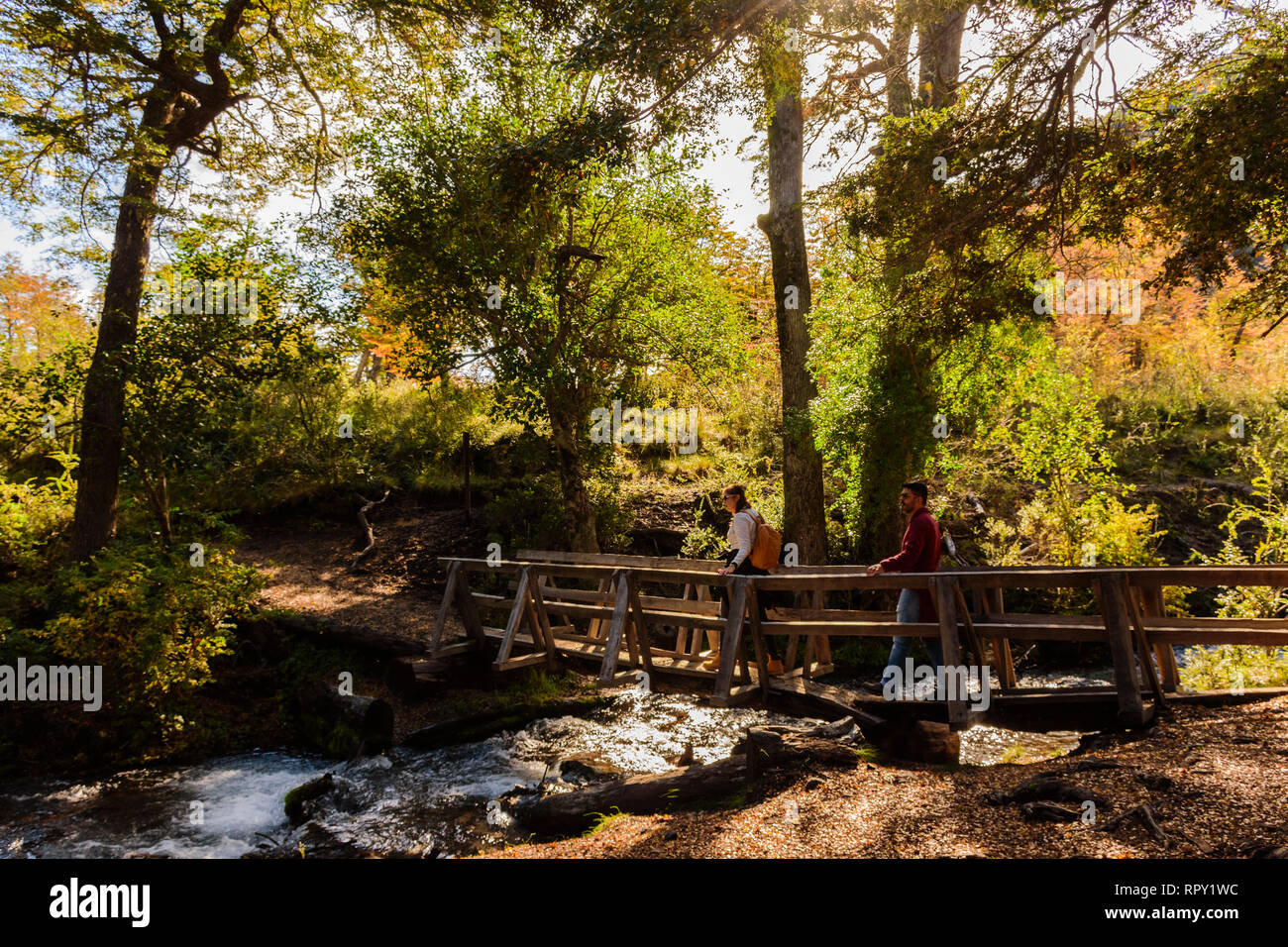 people crossing a wooden bridge over river Stock Photo - Alamy