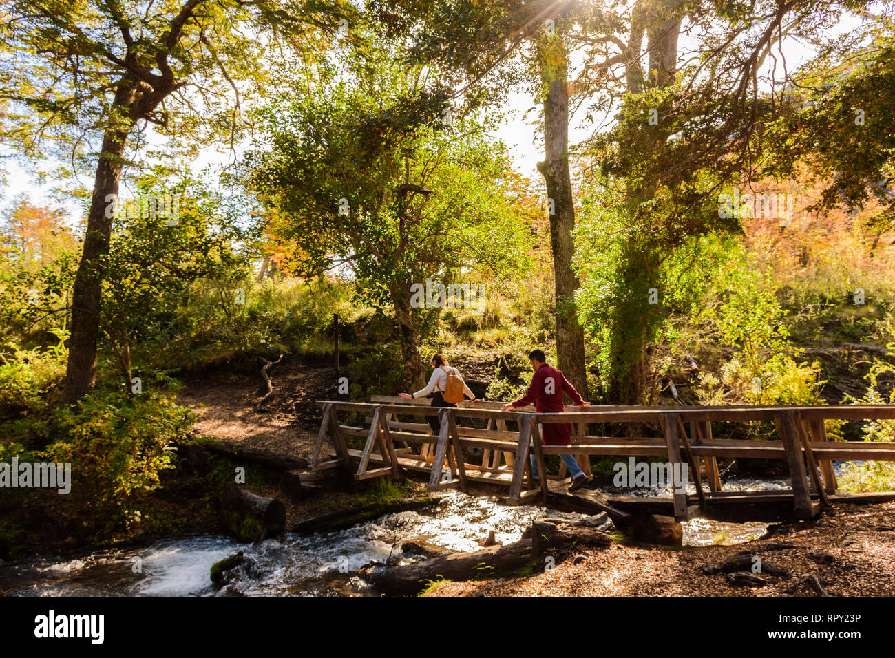 people crossing a wooden bridge over river Stock Photo - Alamy