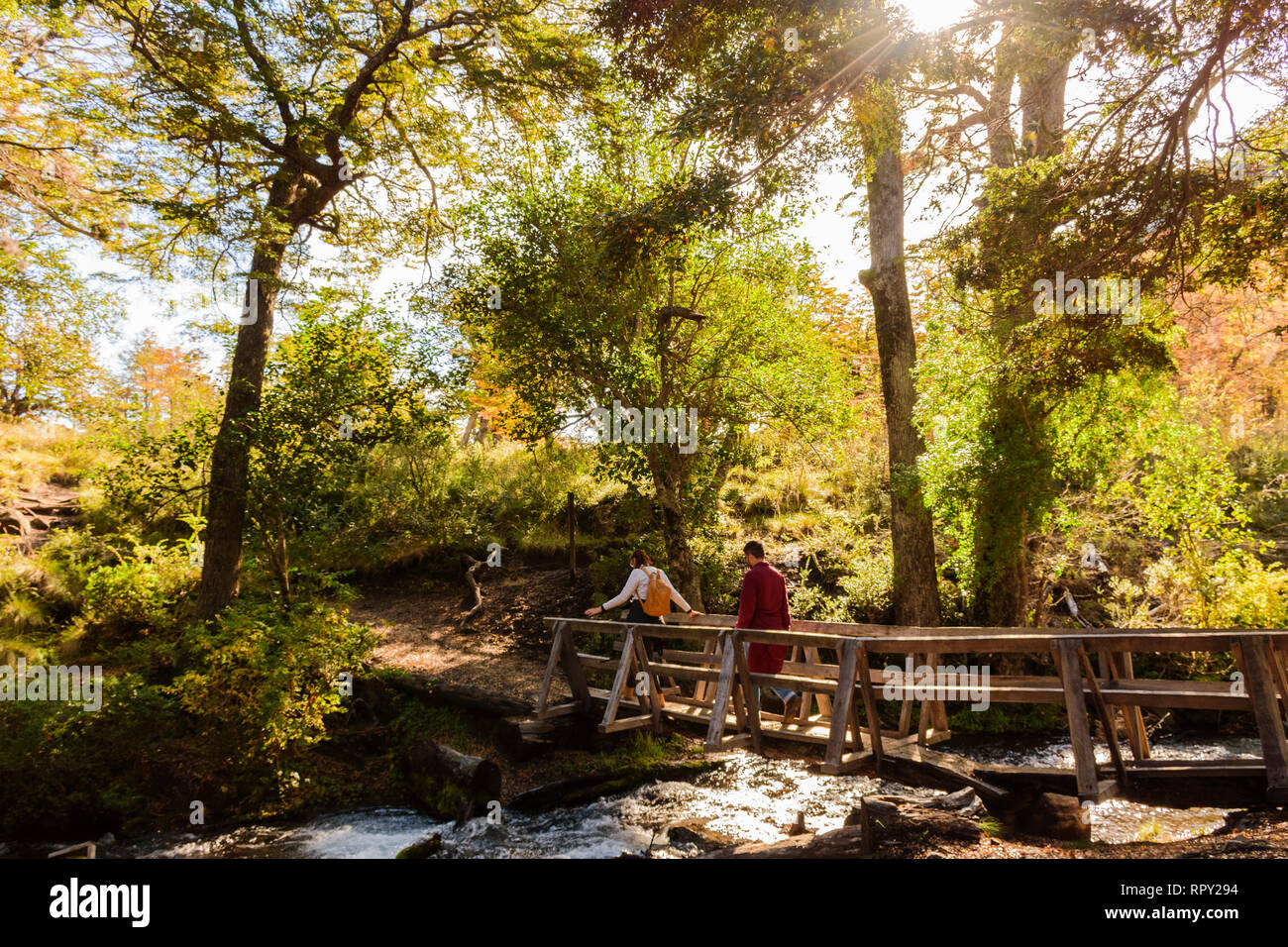 people crossing a wooden bridge over river Stock Photo - Alamy
