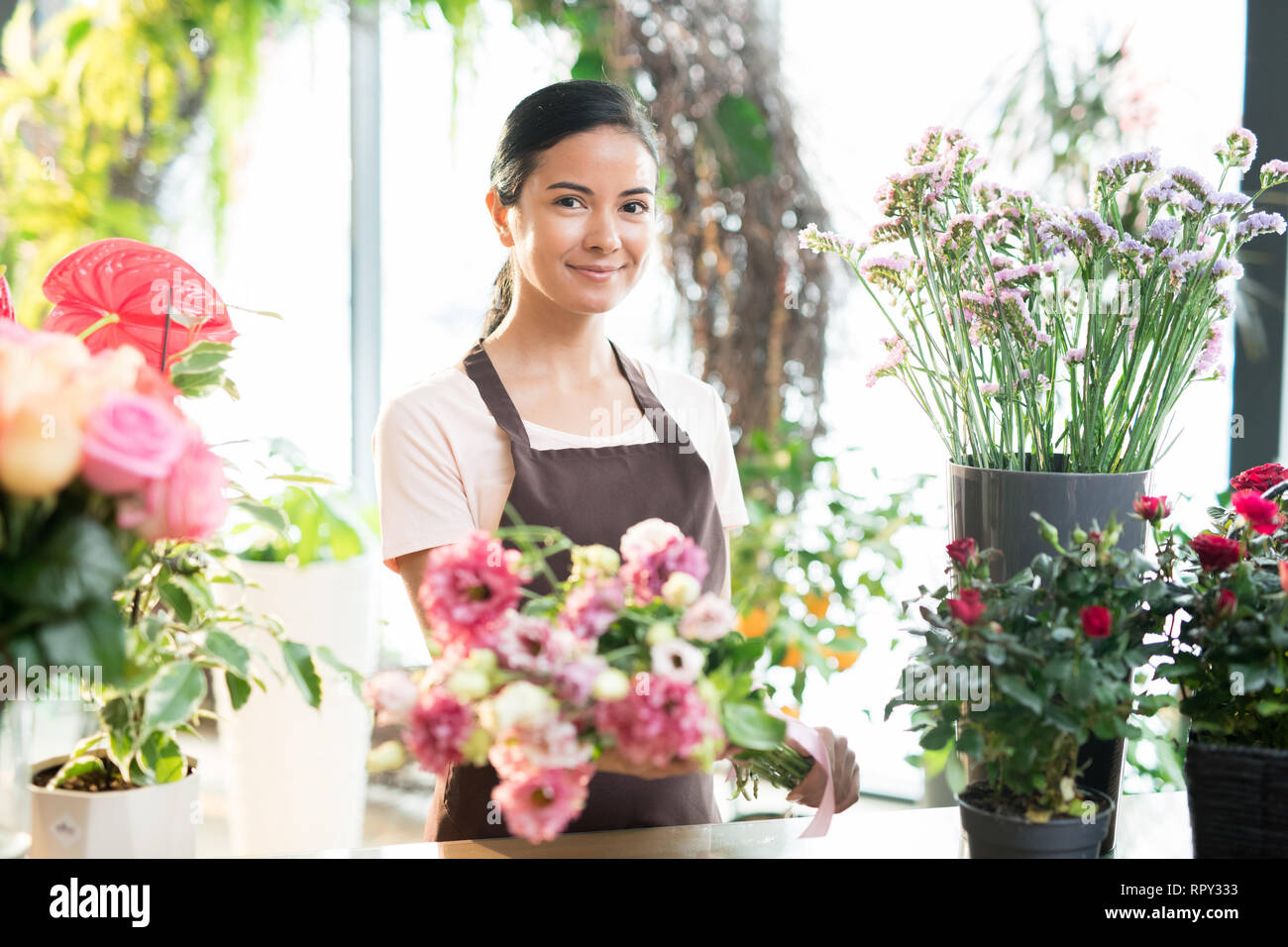Girl working in florist shop Stock Photo - Alamy
