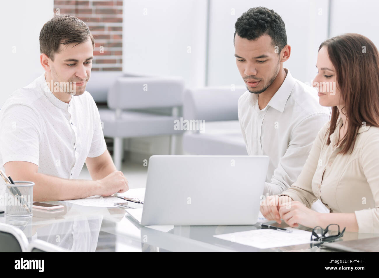 business team sitting at the Desk in the office Stock Photo - Alamy