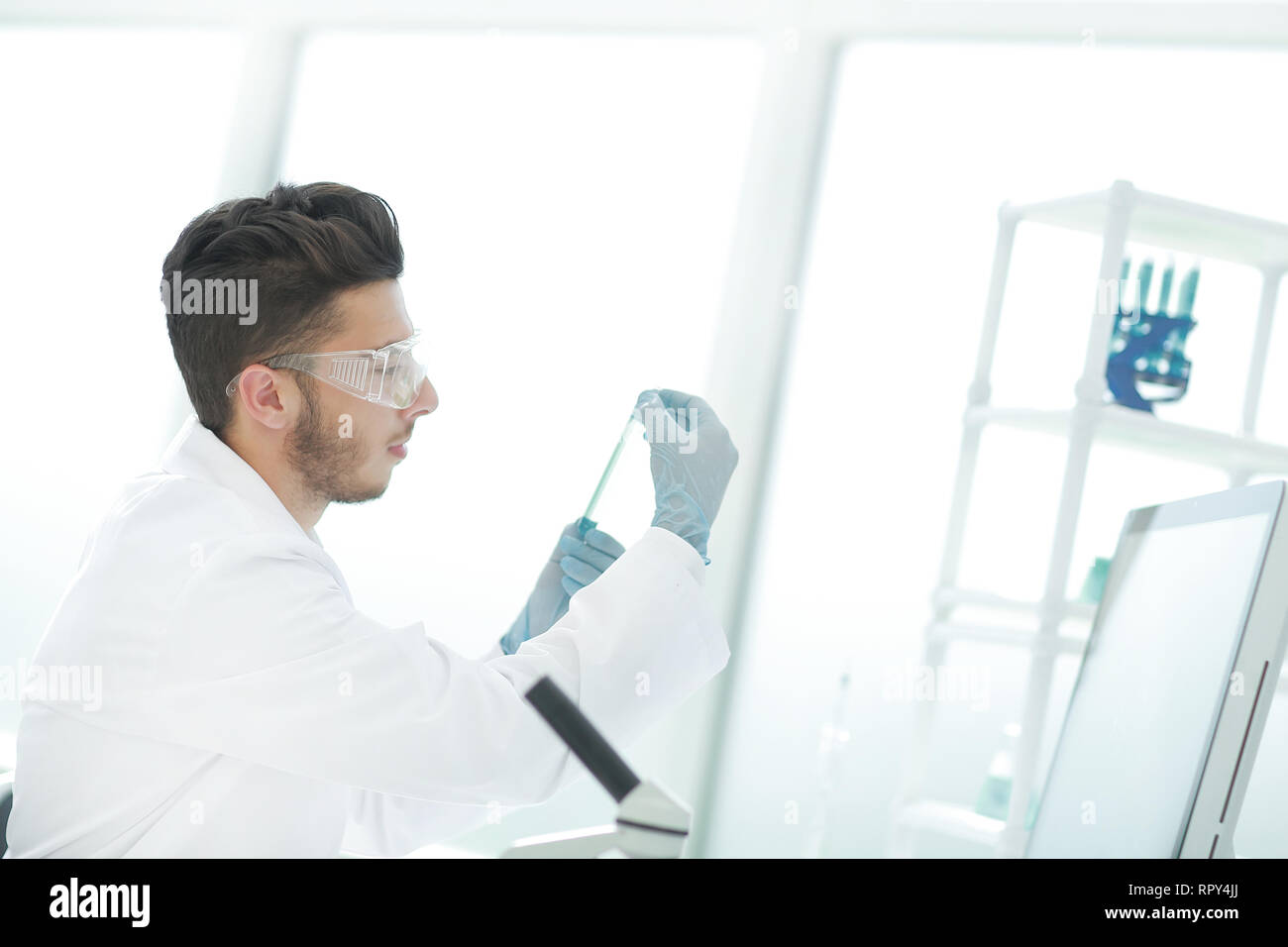 close up. scientist with a medical tube standing in the lab Stock Photo ...