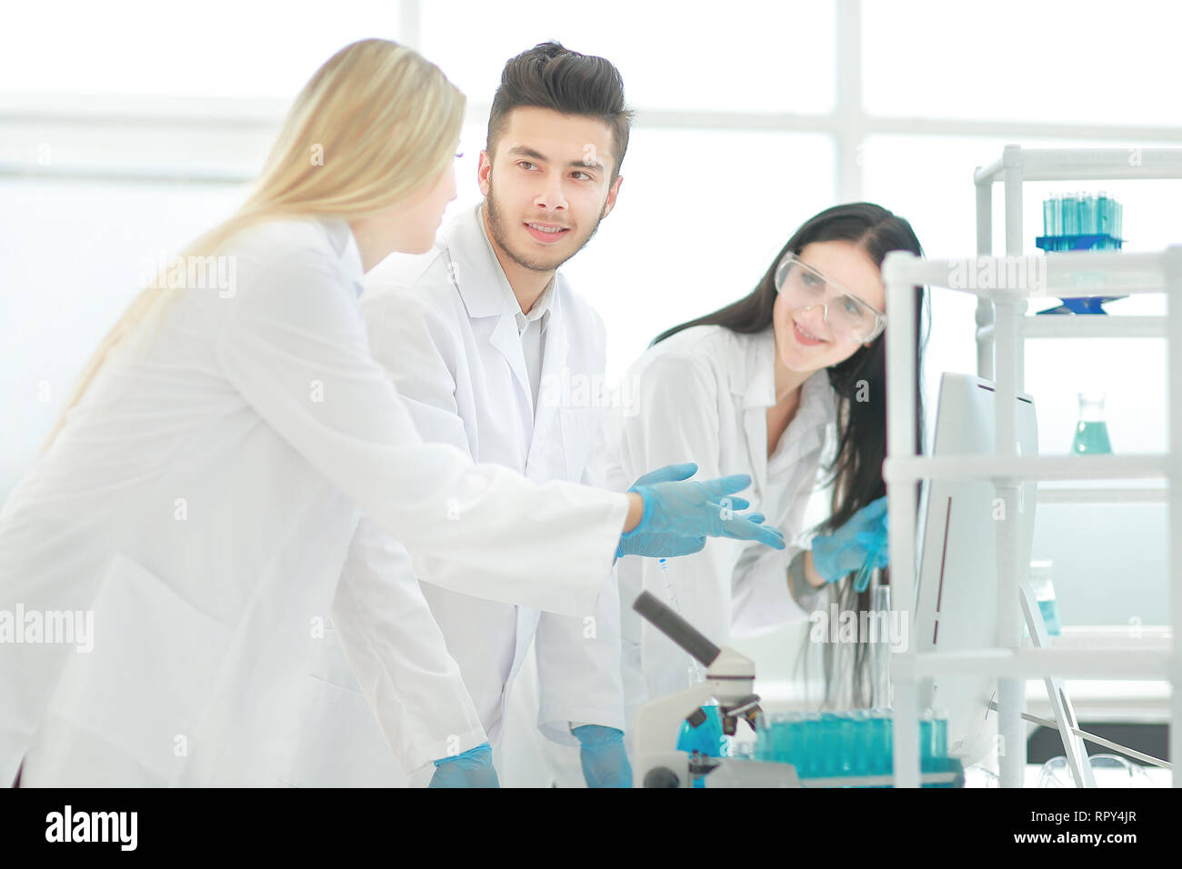 group of young scientist discussing something in their lab Stock Photo ...